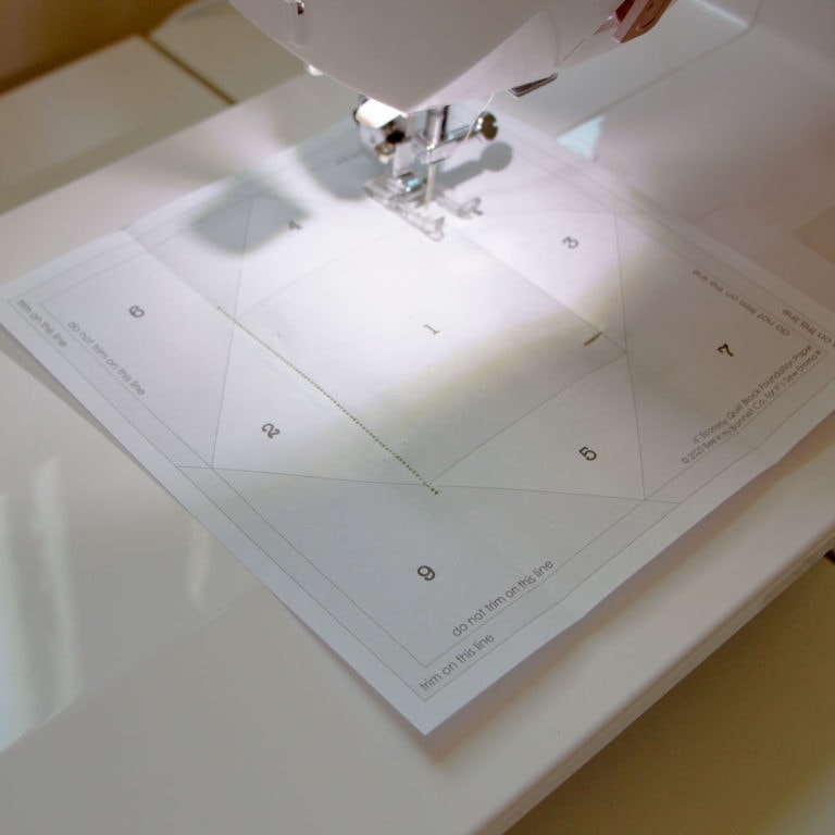 Sew your block with the print side up. Stitch directly on the line ...