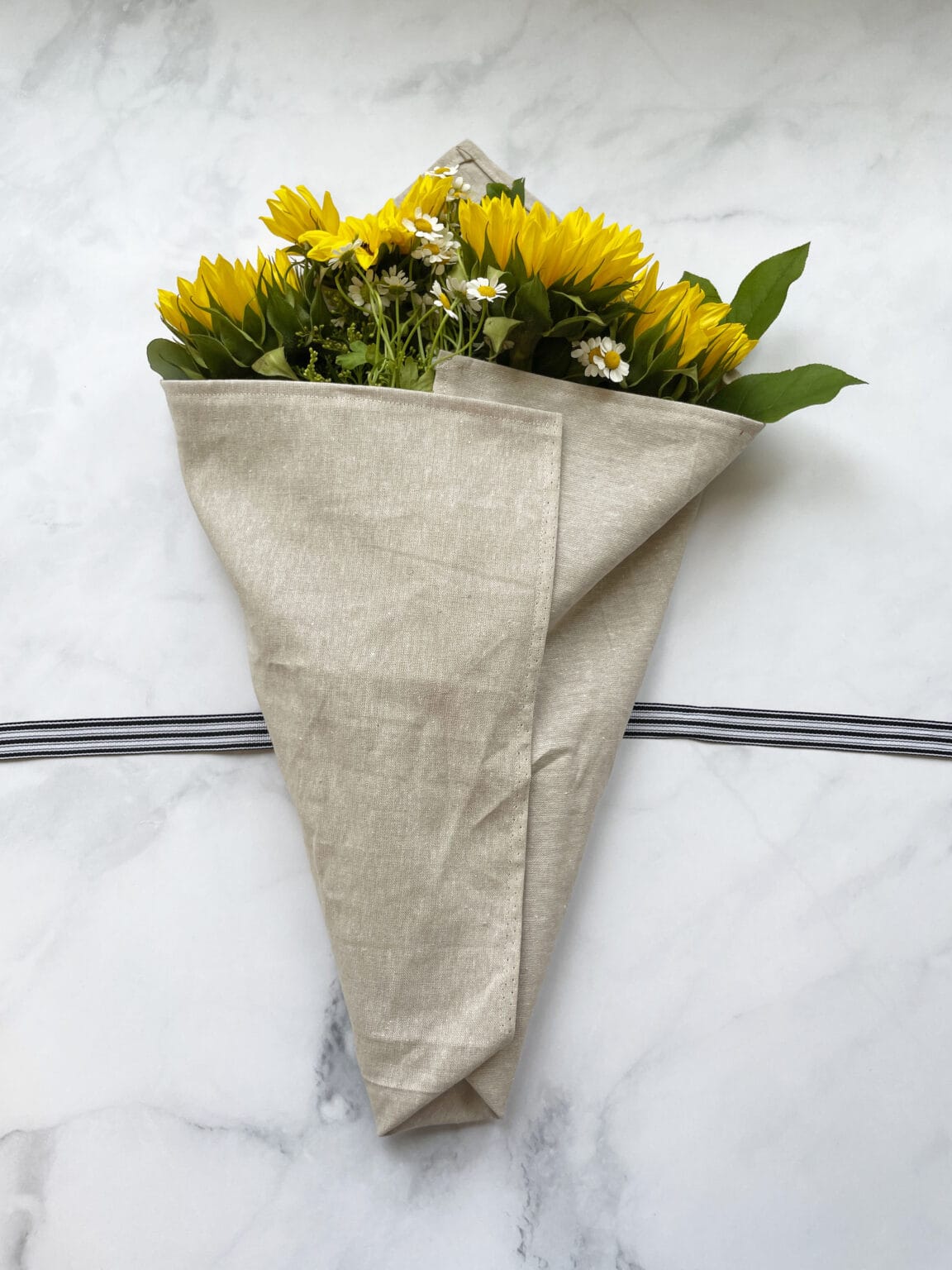 4. Tie the ribbon around your bouquet wrap, and it’s ready to gift!