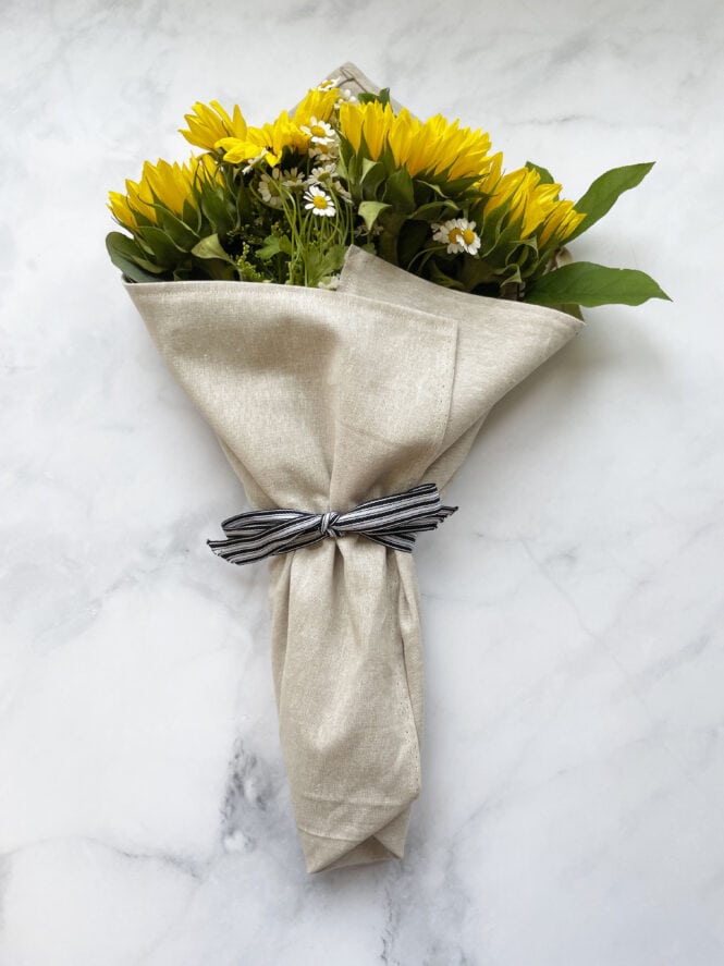 4. Tie the ribbon around your bouquet wrap, and it’s ready to gift!