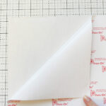 3. Peel off the backing from the self-stick mounting board and ...